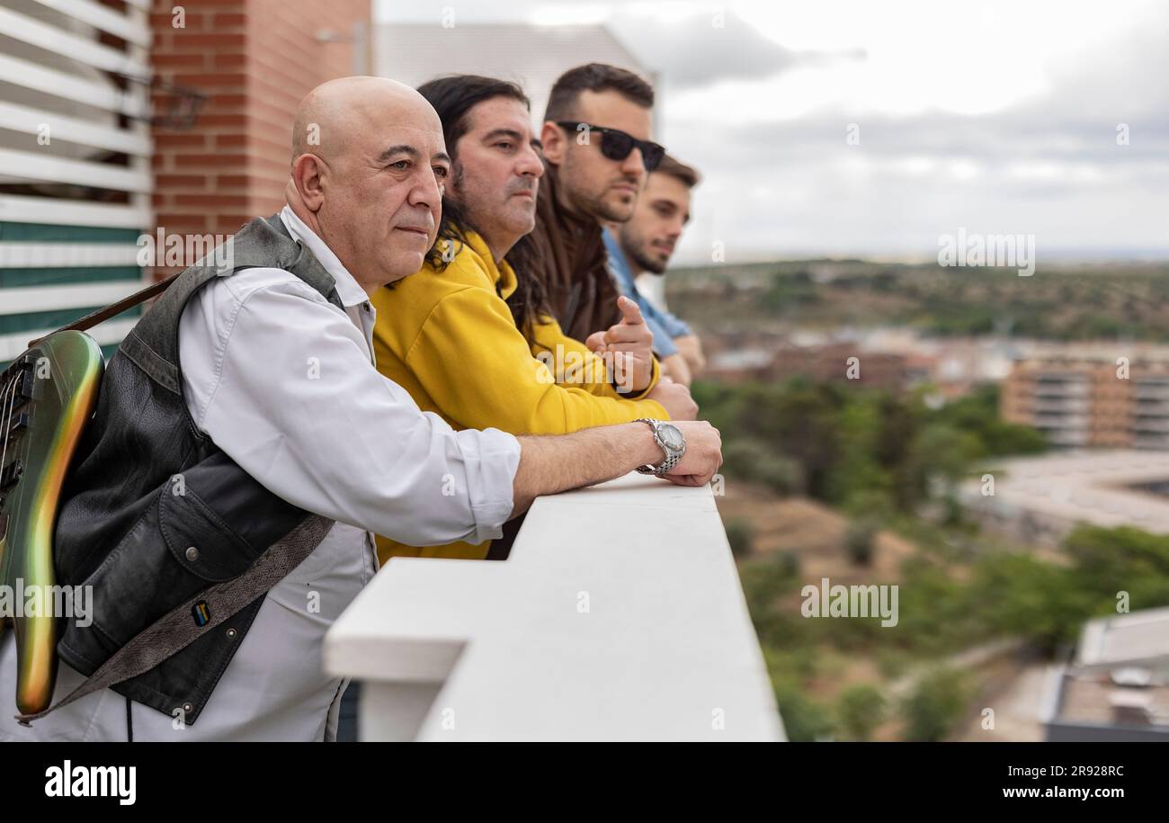 Rock musicians standing together on rooftop Stock Photo - Alamy