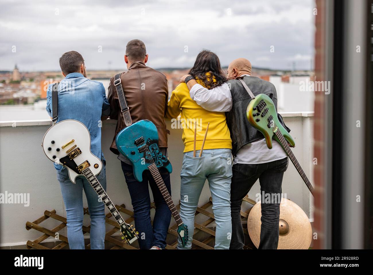 Rock musicians standing together with electric guitars on rooftop Stock ...