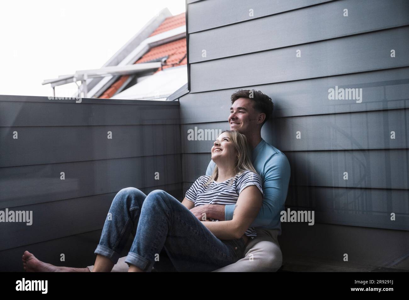 Couple sitting on balcony hi-res stock photography and images - Alamy