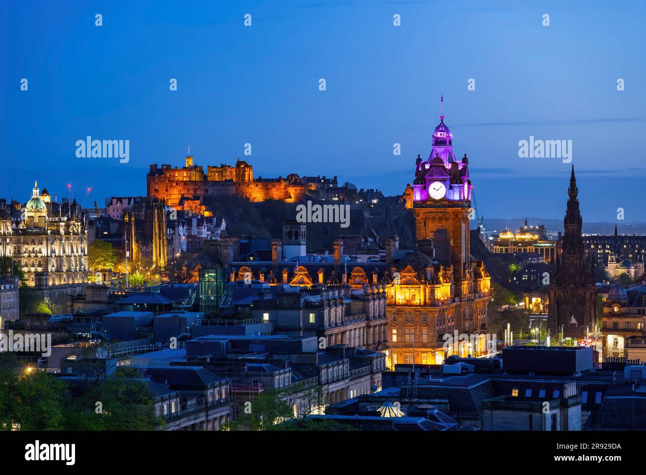 UK, Scotland, Edinburgh, City at dusk with clock tower in background ...