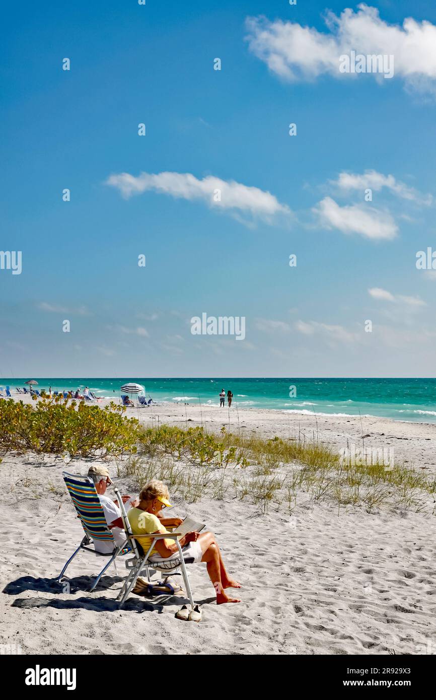 Mature couple sunbathing on beach hi-res stock photography and images ...