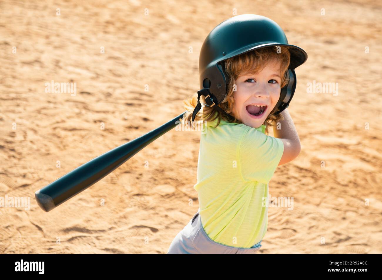 Excited child baseball player focused ready to bat. Kid holding a ...