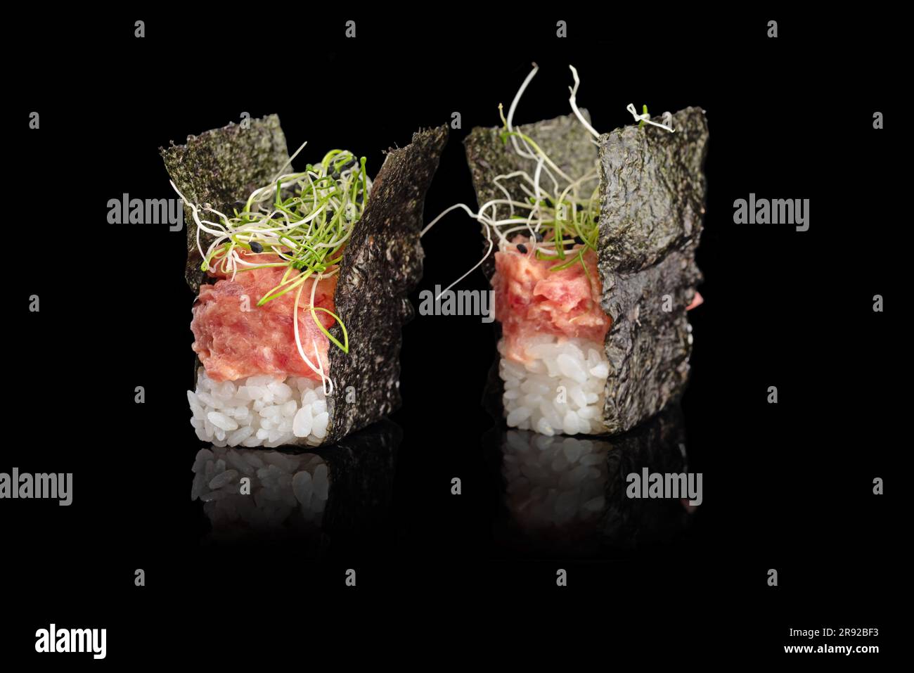 Gunkan sushi with tuna tartare with reflection a black background. menu ...