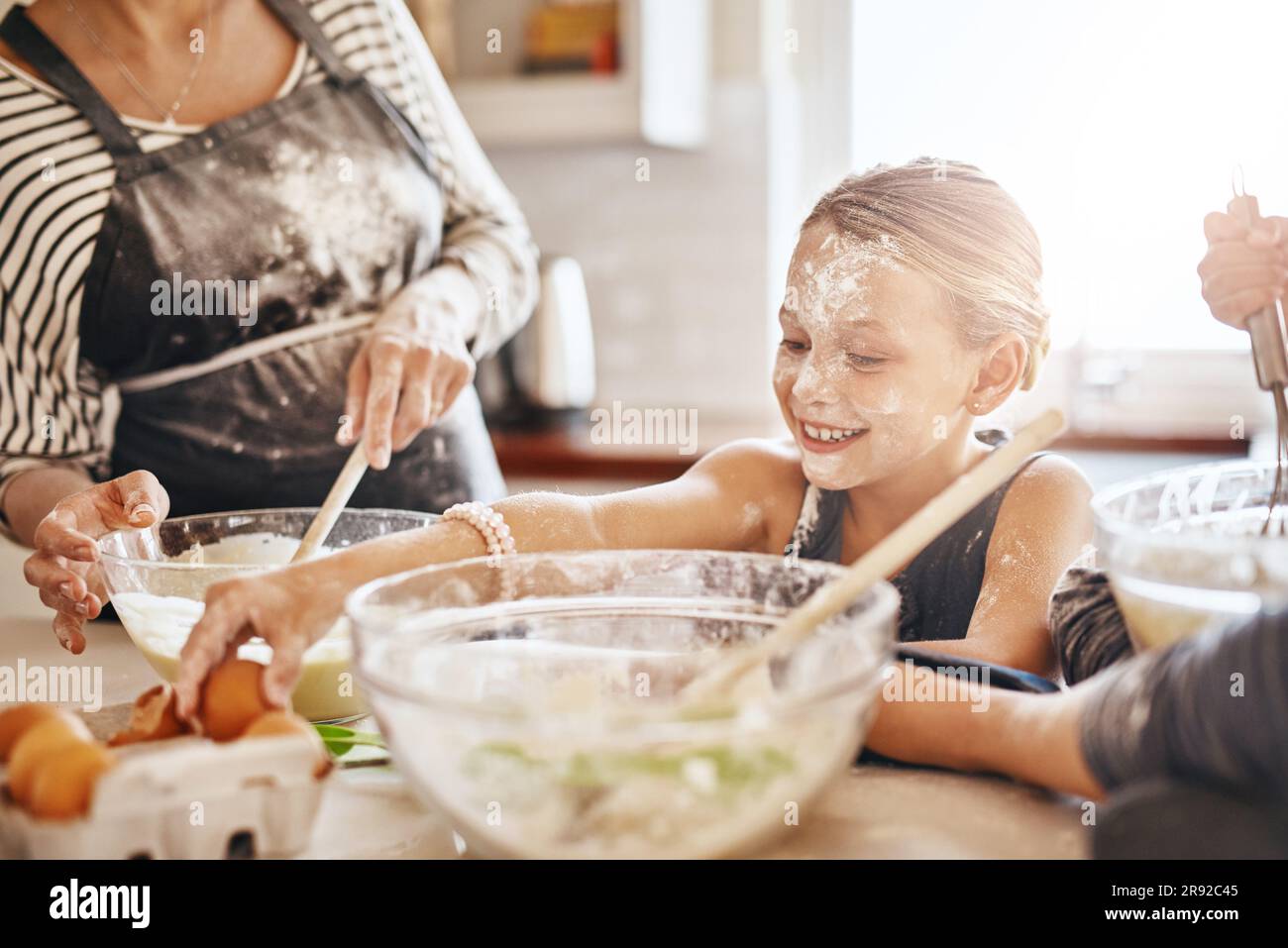 Learning, playing or messy kid baking in kitchen with a young girl ...