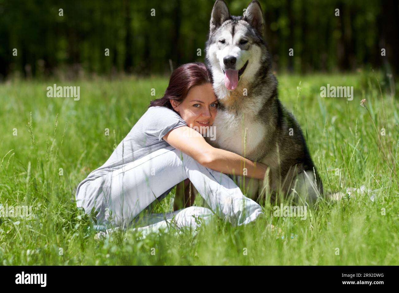 Woman, husky and smile in portrait, field or park with hug, love and ...