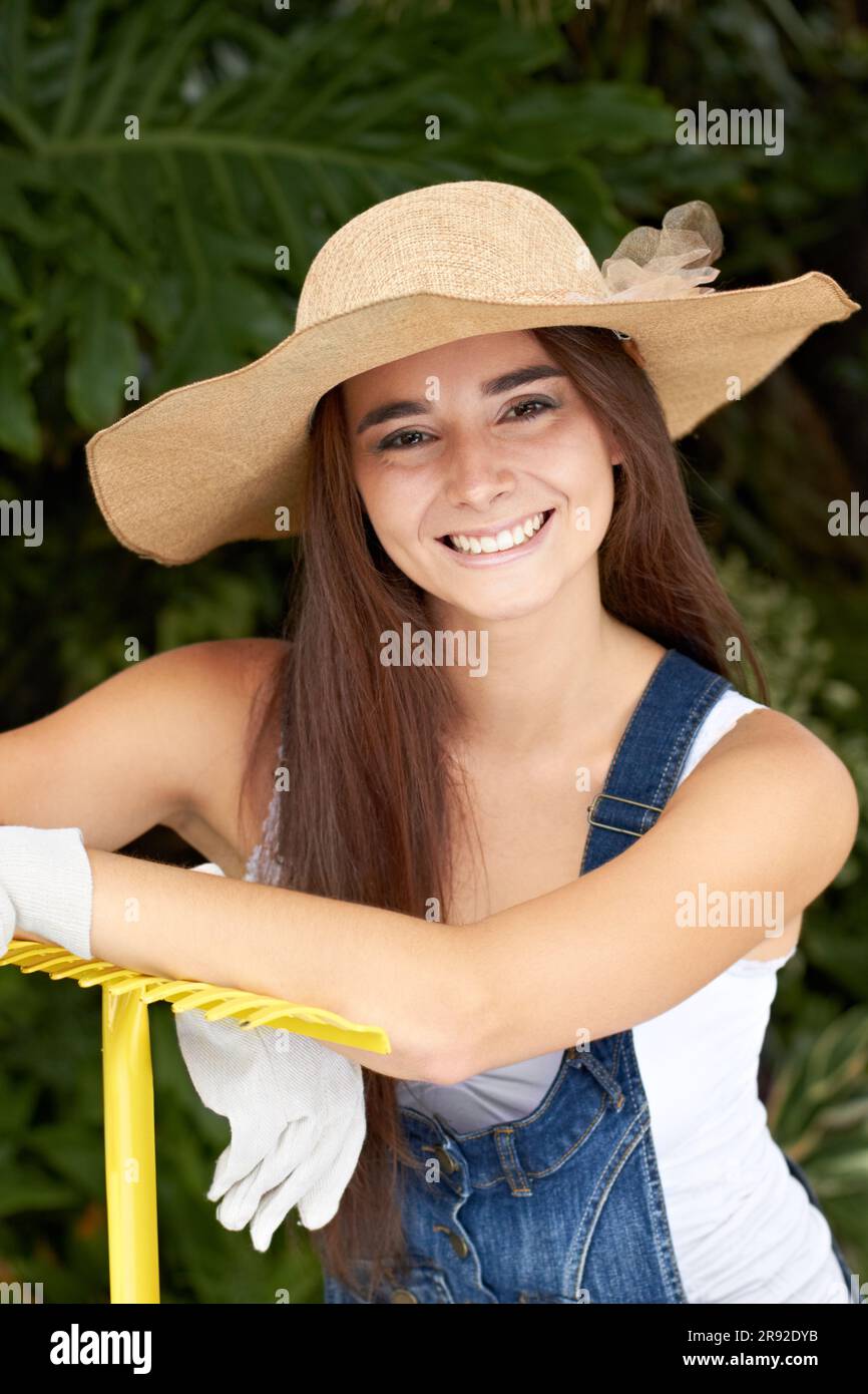Young woman with rake, smile and gardening in portrait with nature ...
