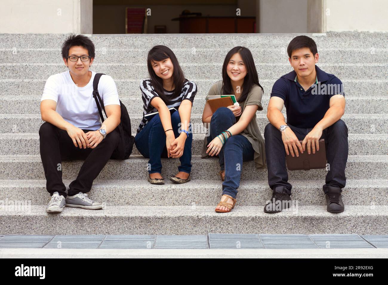 Asian friends, portrait and university on stairs with smile, learning ...