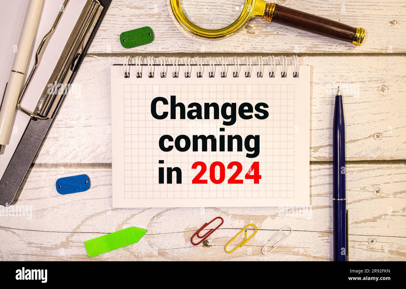 CHANGE COMING IN 2024. red and black font on white paper on the table ...