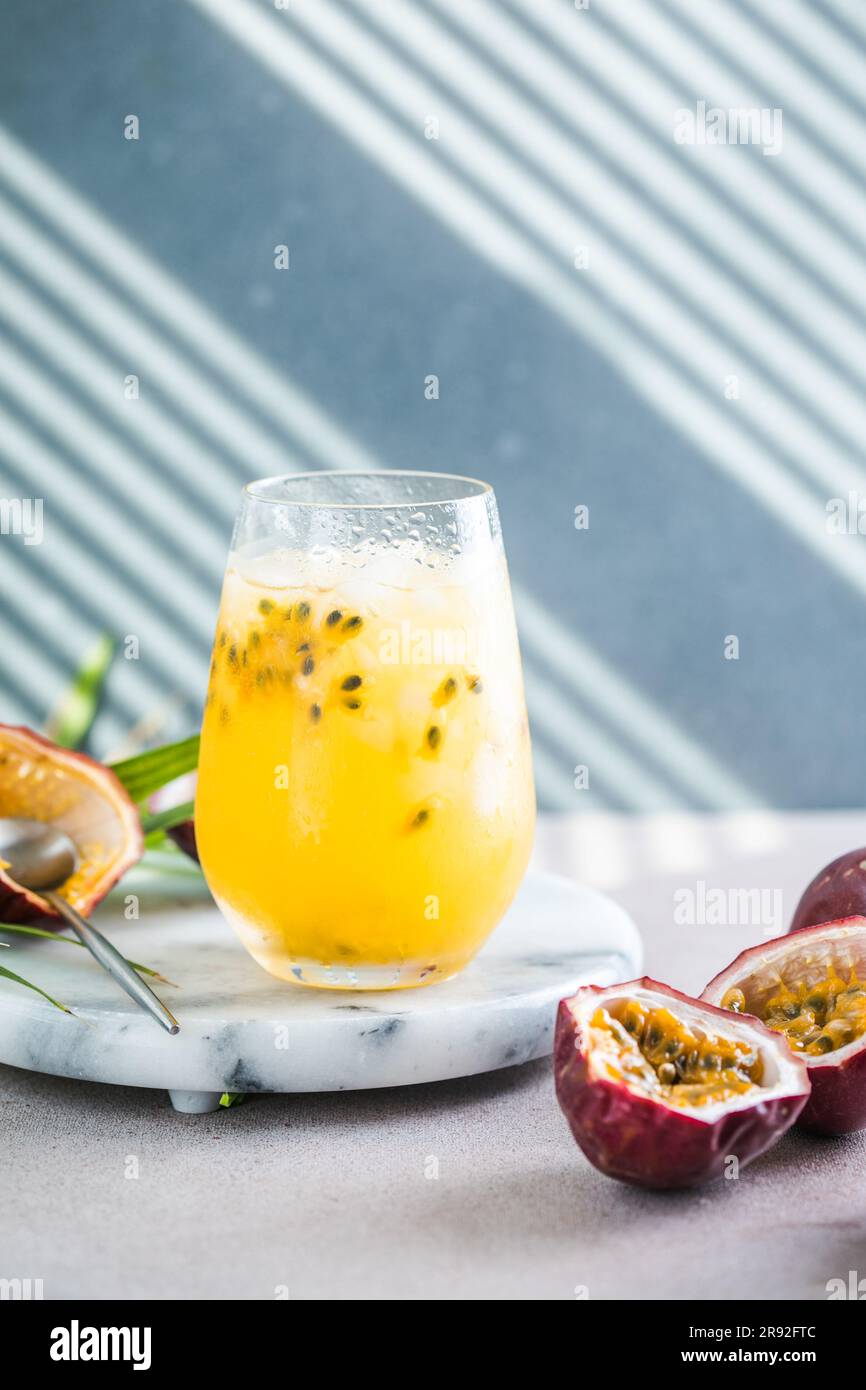 Glass of Iced passion fruit soda with lemon and passion fruit half ...