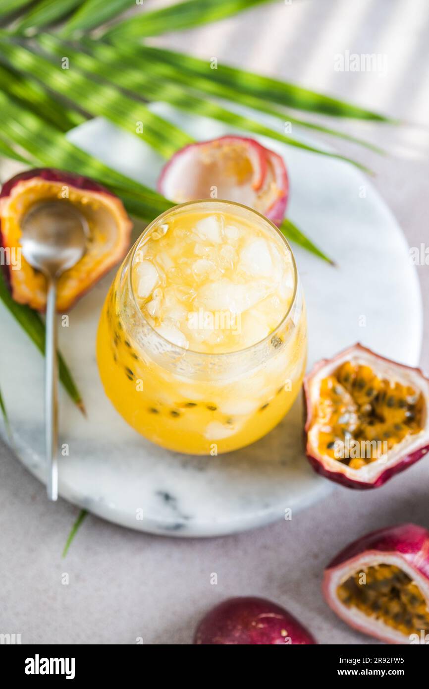 Glass of Iced passion fruit soda with lemon and passion fruit half ...