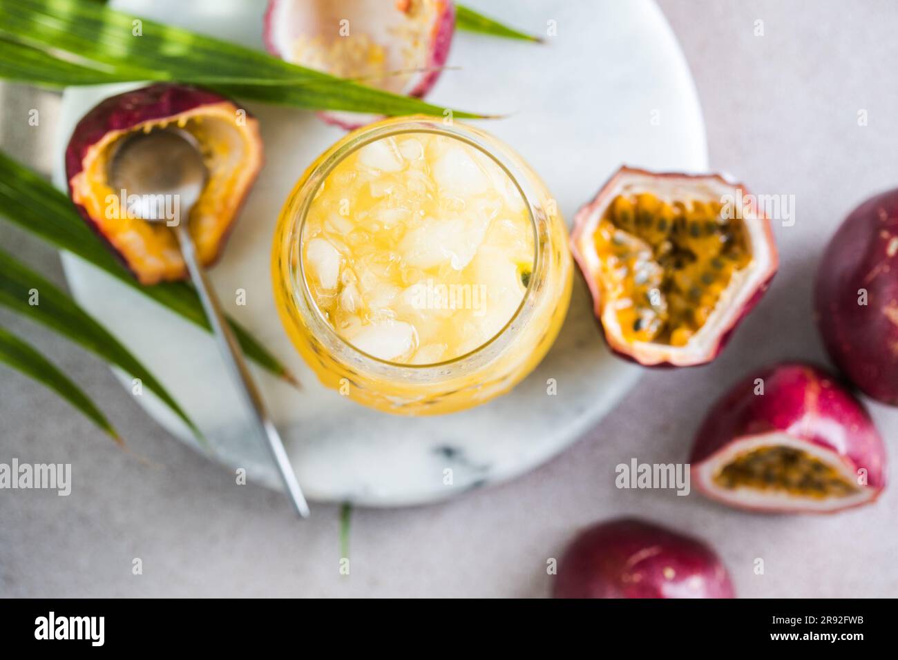 Glass of Iced passion fruit soda with lemon and passion fruit half ...