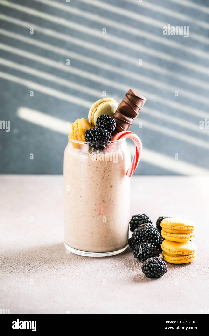 Chocolate indulgent extreme milkshake with macaroons, berry and sweets ...