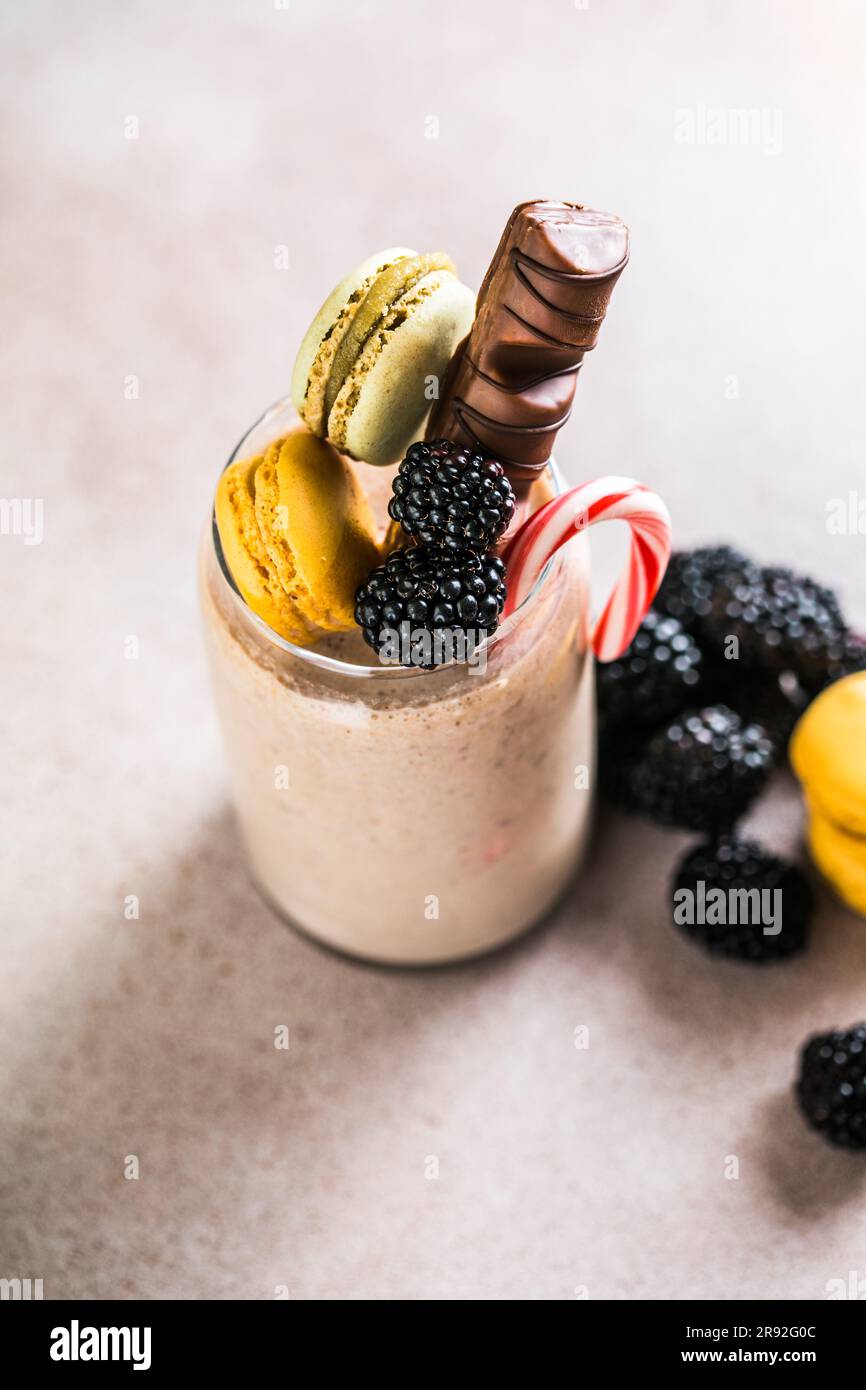 Chocolate indulgent extreme milkshake with macaroons, berry and sweets ...