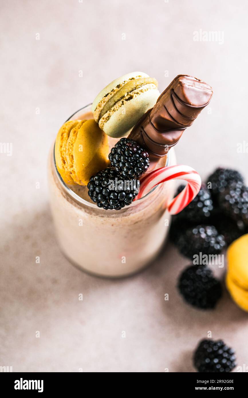 Chocolate indulgent extreme milkshake with macaroons, berry and sweets ...
