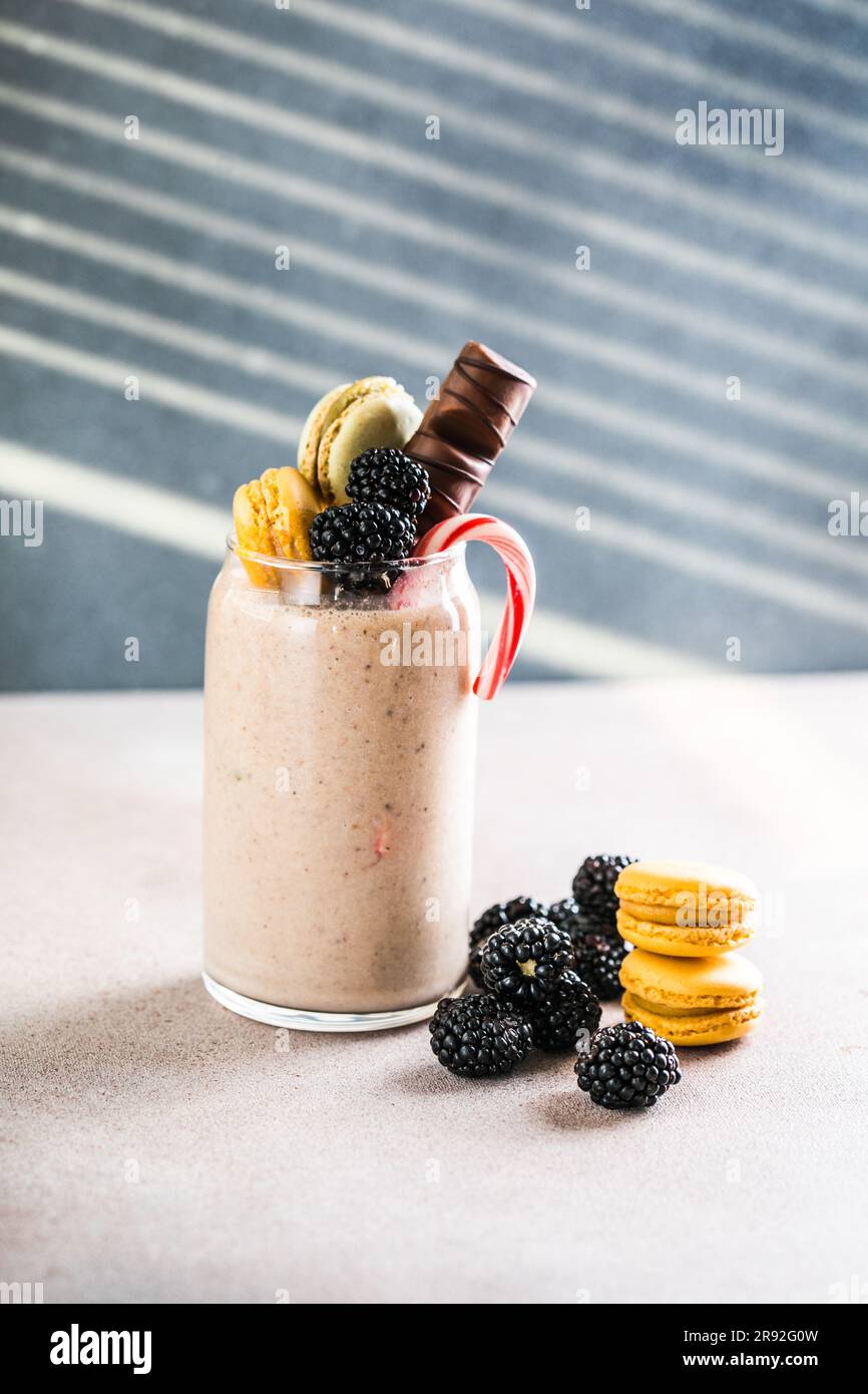 Chocolate indulgent extreme milkshake with macaroons, berry and sweets ...