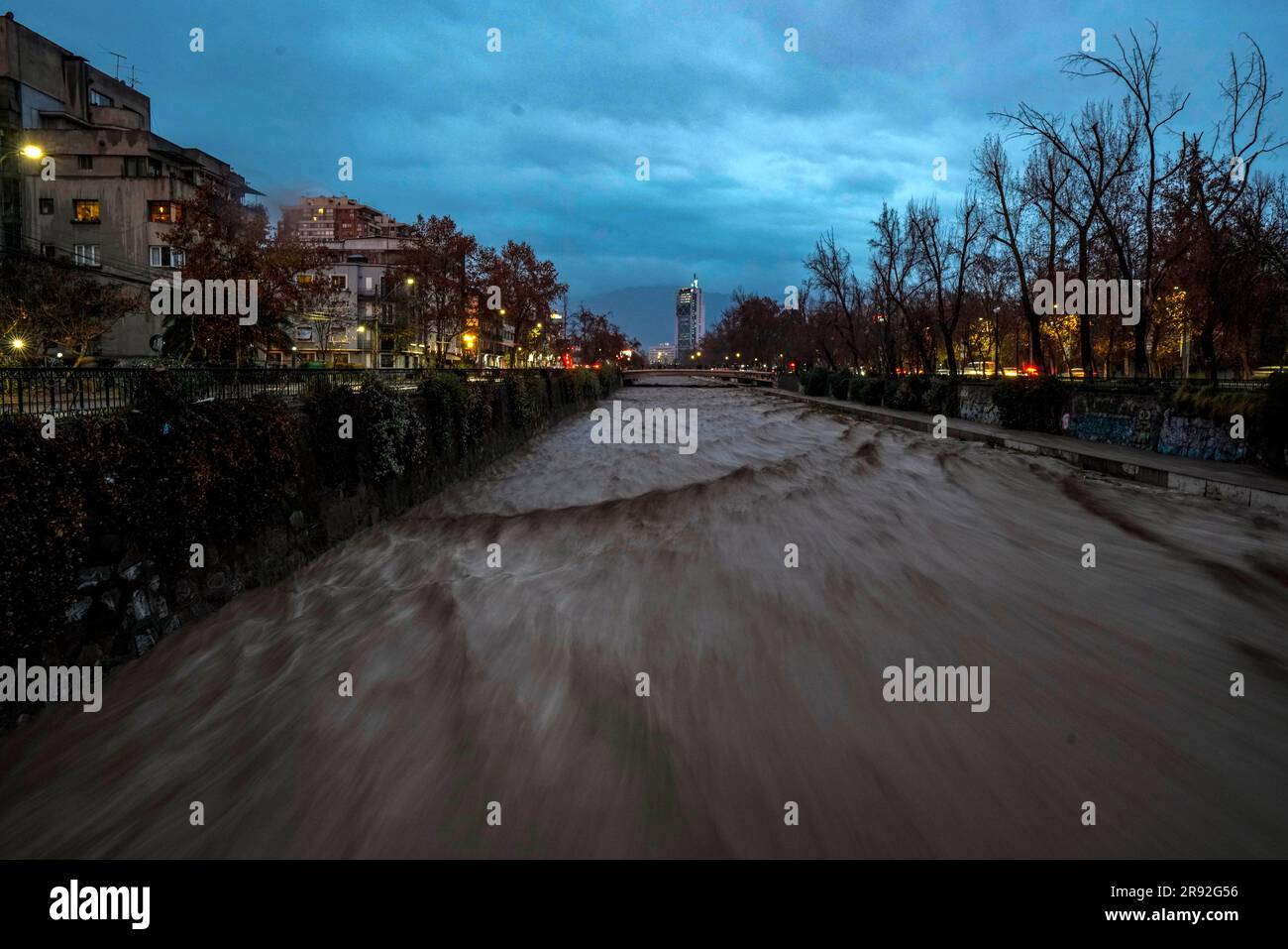 A rising Mapocho River flows during a heavy rainfall in downtown ...
