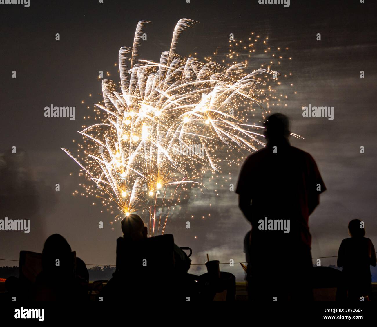Some people watching beautiful fireworks Stock Photo - Alamy