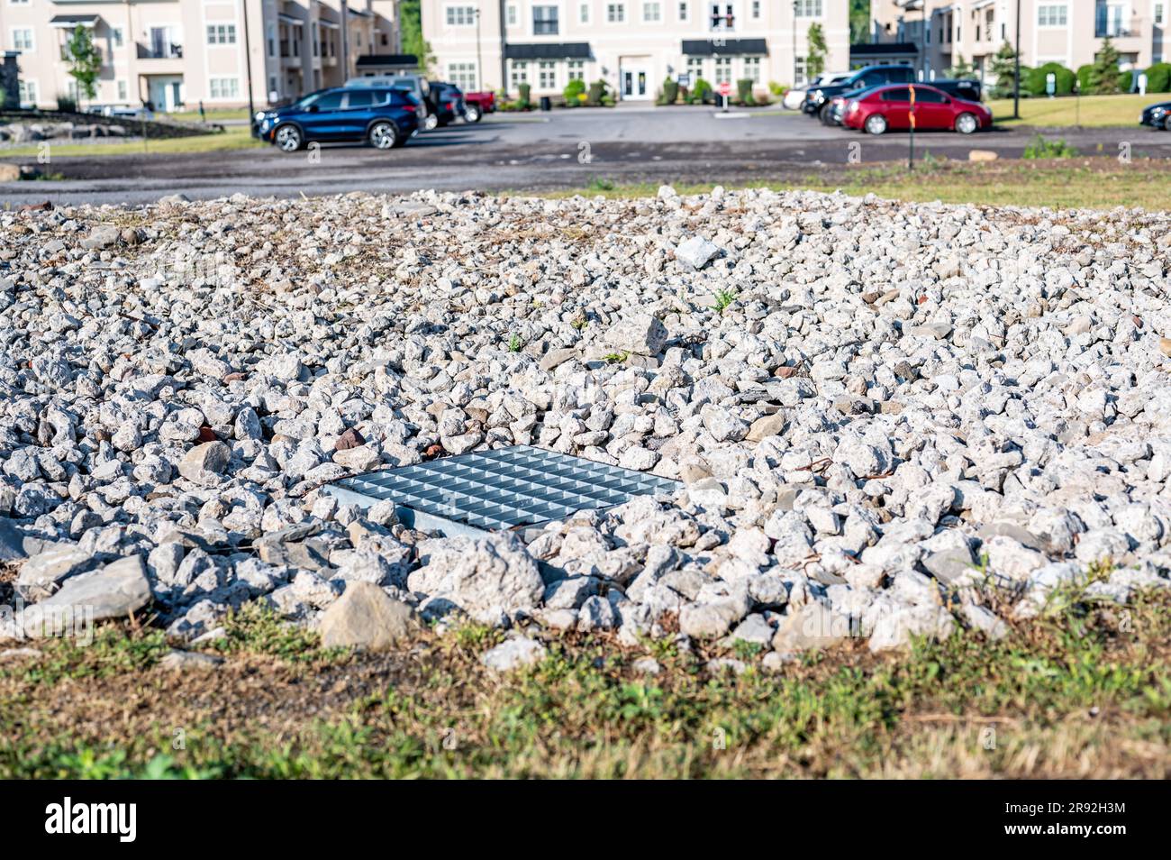 Grated storm drain inlet surrounded by rock for soil erosion control ...