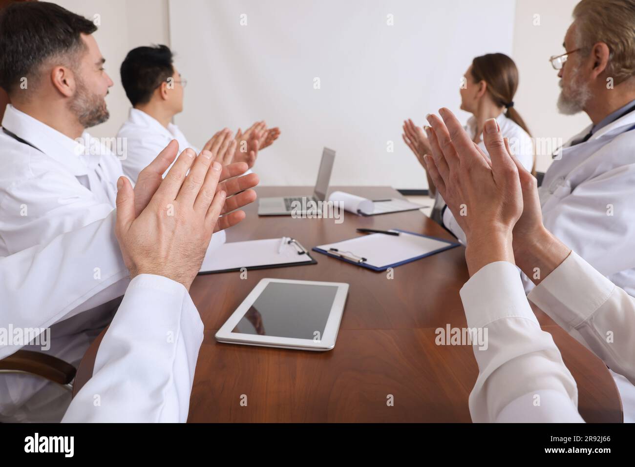 Team of doctors using video projector during conference indoors Stock ...