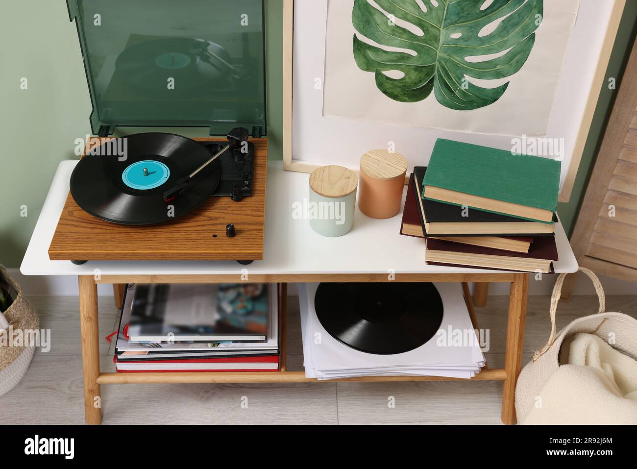 Stylish turntable with vinyl record console table in room Stock Photo ...