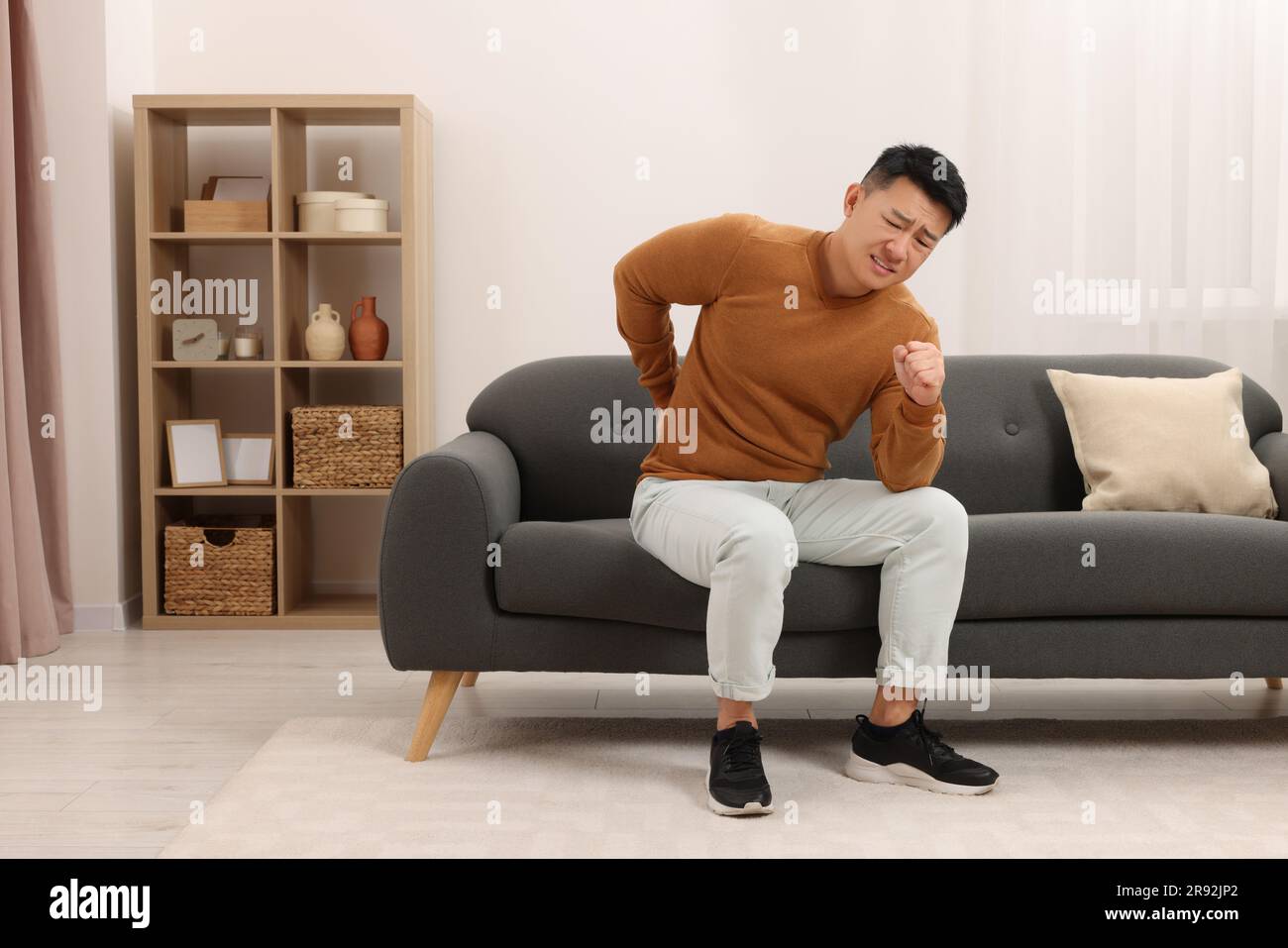 Asian man touching back suffering hi-res stock photography and images ...