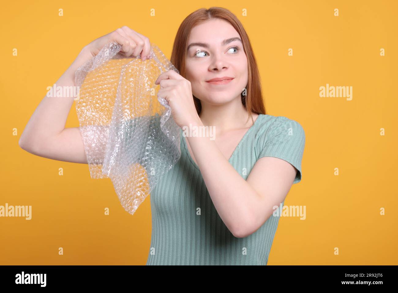 Woman popping bubble wrap hi-res stock photography and images - Alamy