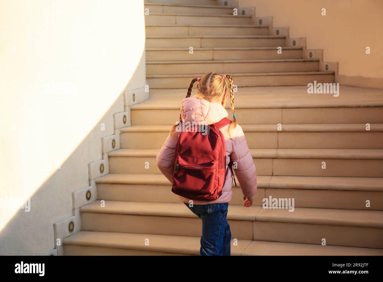 Cute little girl with backpack on stairs outdoors, back view Stock ...