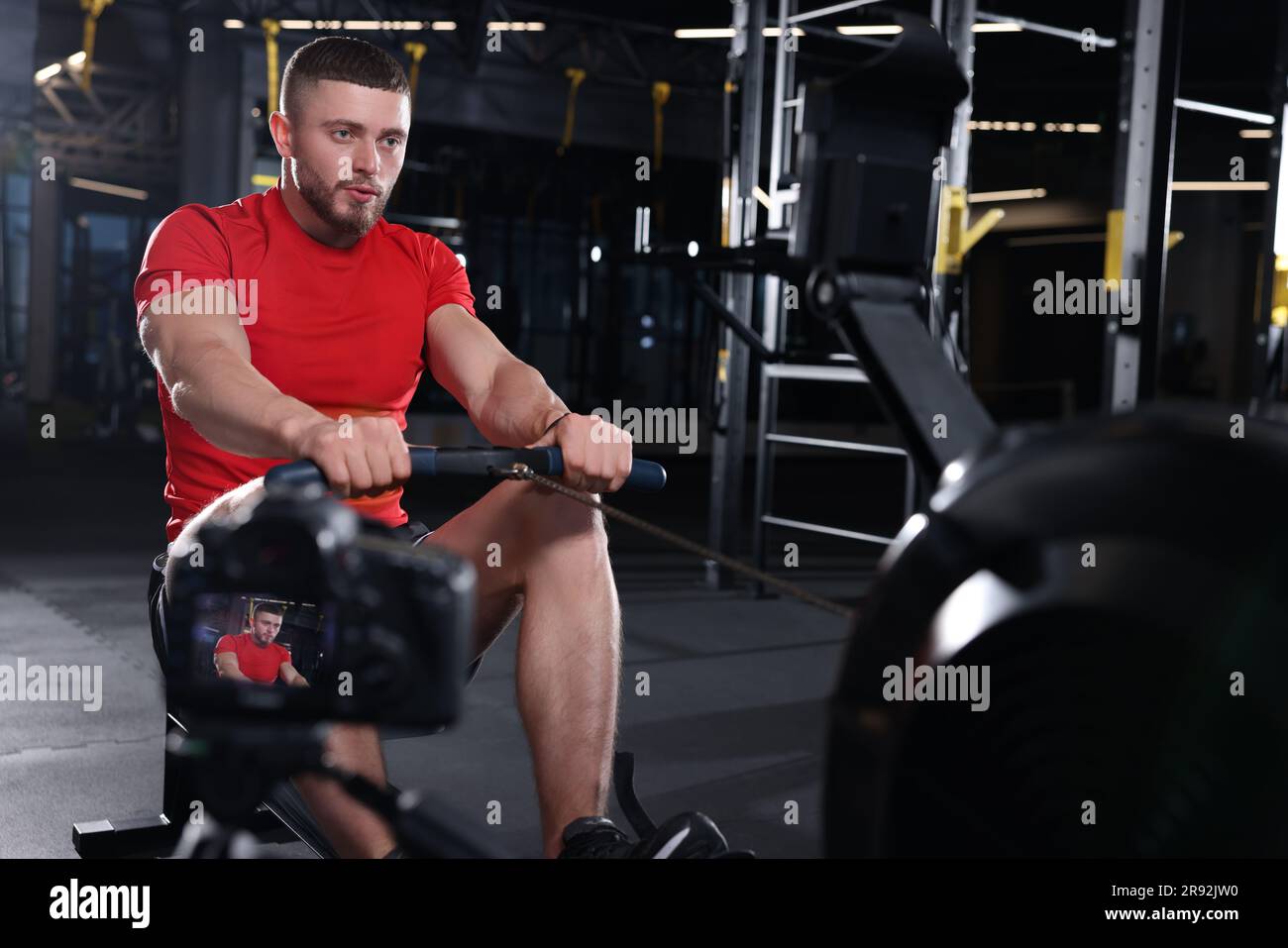 Man recording workout on camera at gym. Online fitness trainer Stock ...