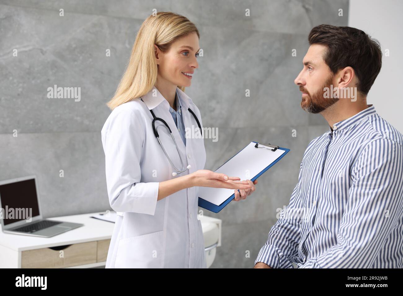 Patient having appointment with doctor in clinic Stock Photo - Alamy
