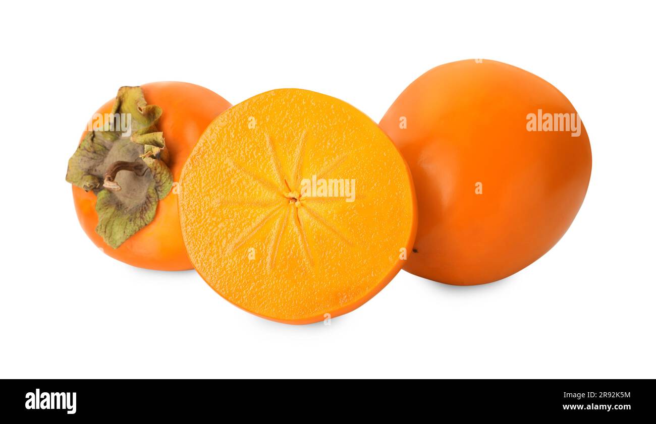 Whole and cut delicious ripe juicy persimmons on white background Stock ...