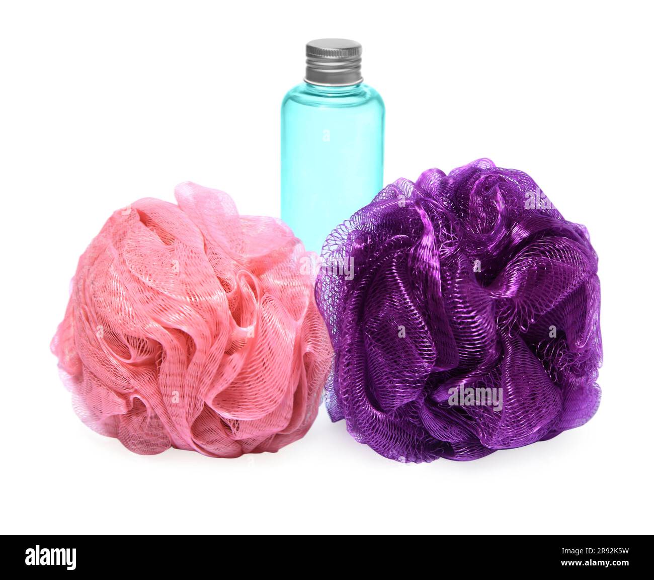 New shower puffs and bottle of cosmetic product on white background ...