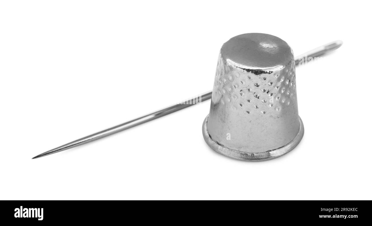 Sewing thimble and needle isolated on white Stock Photo - Alamy