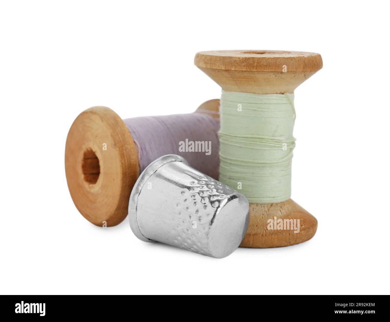 Thimble and spools of sewing threads isolated on white Stock Photo - Alamy