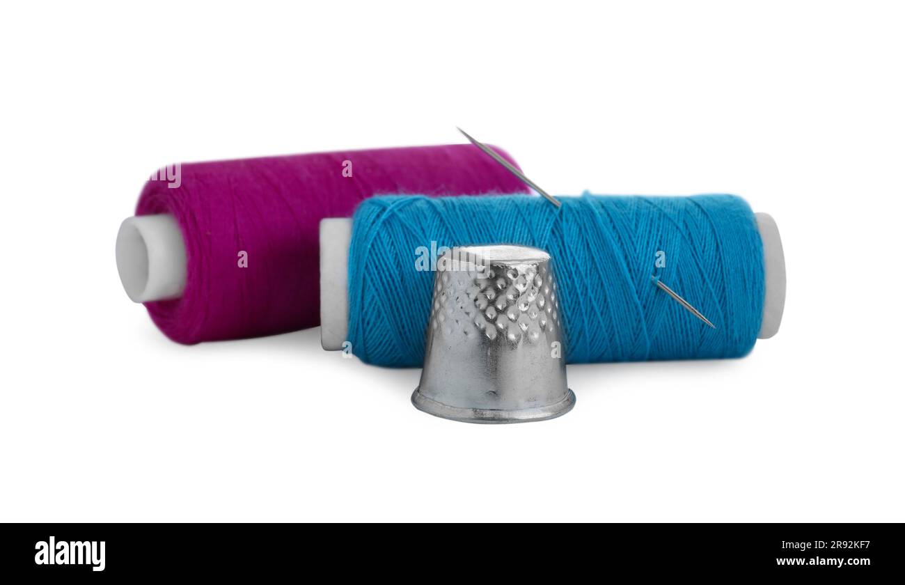 Thimble, spools of sewing threads and needle isolated on white Stock ...