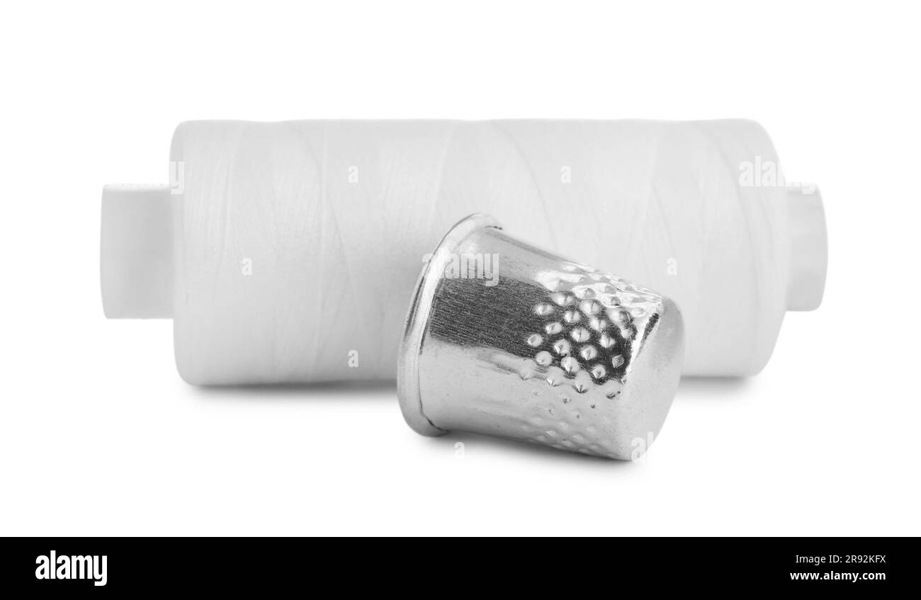 Thimble and spool of sewing thread isolated on white Stock Photo - Alamy
