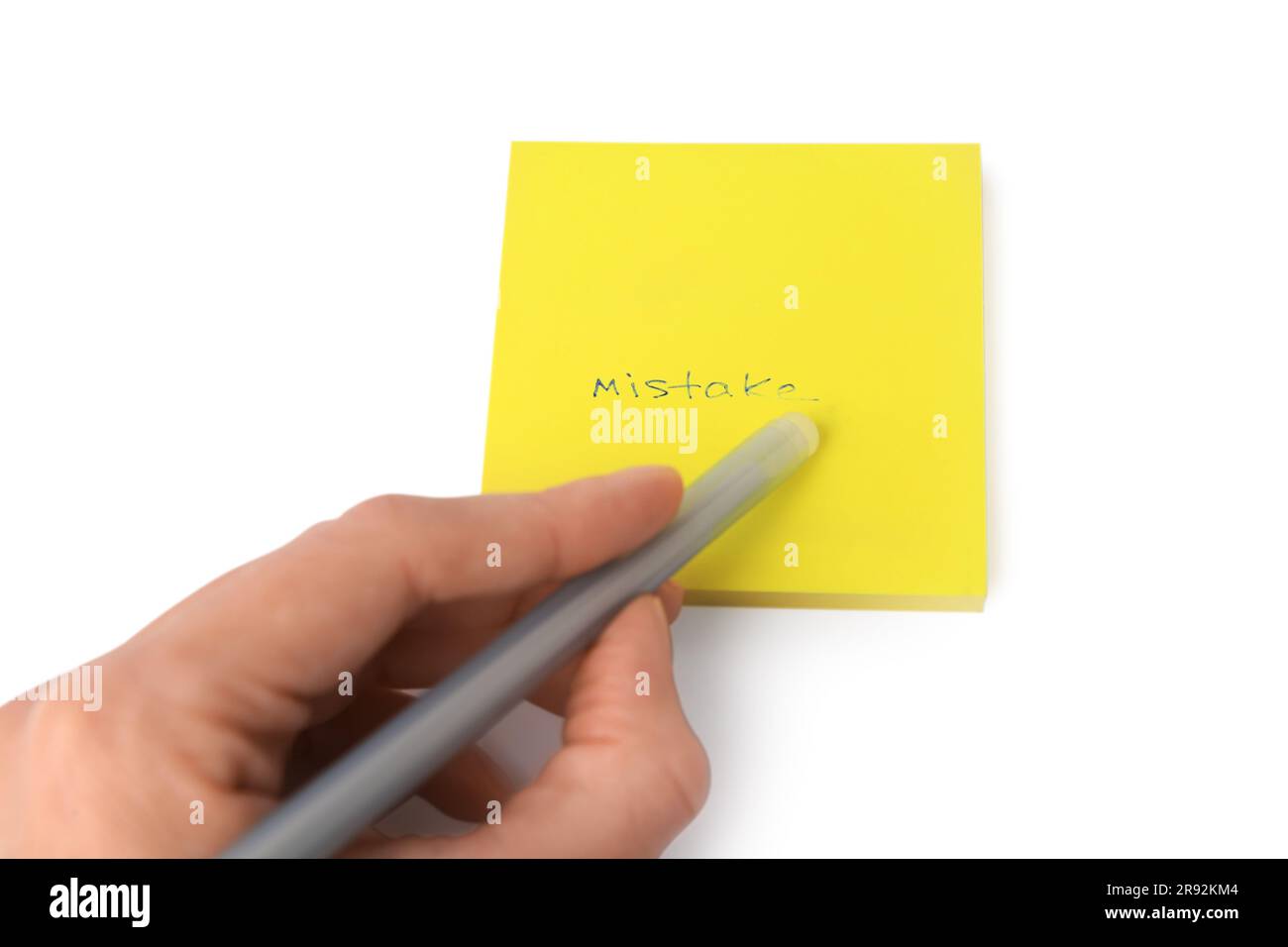 Child erasing word Mistake written with erasable pen on sticky note ...