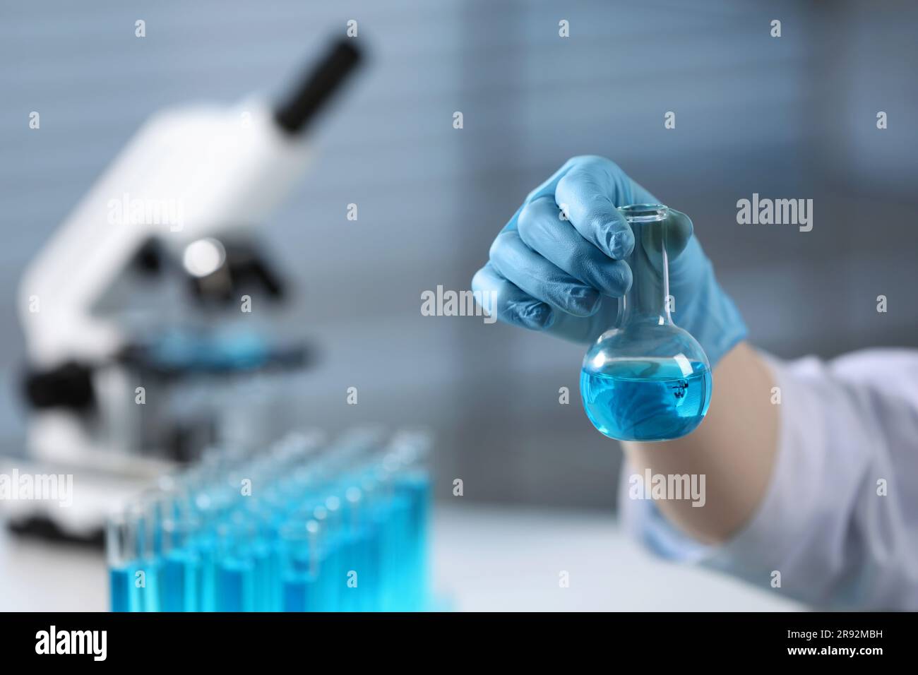 Scientist holding flask in laboratory, space for text Stock Photo - Alamy
