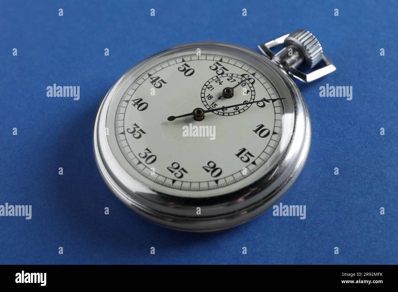 Vintage timer on blue background. Measuring tool Stock Photo - Alamy