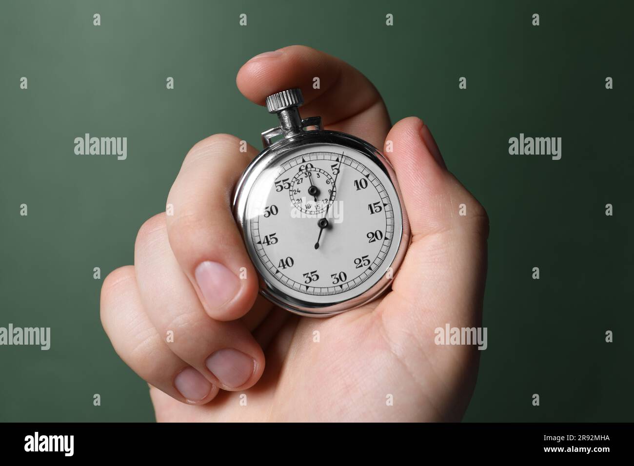 Man holding vintage timer on green background, closeup Stock Photo - Alamy