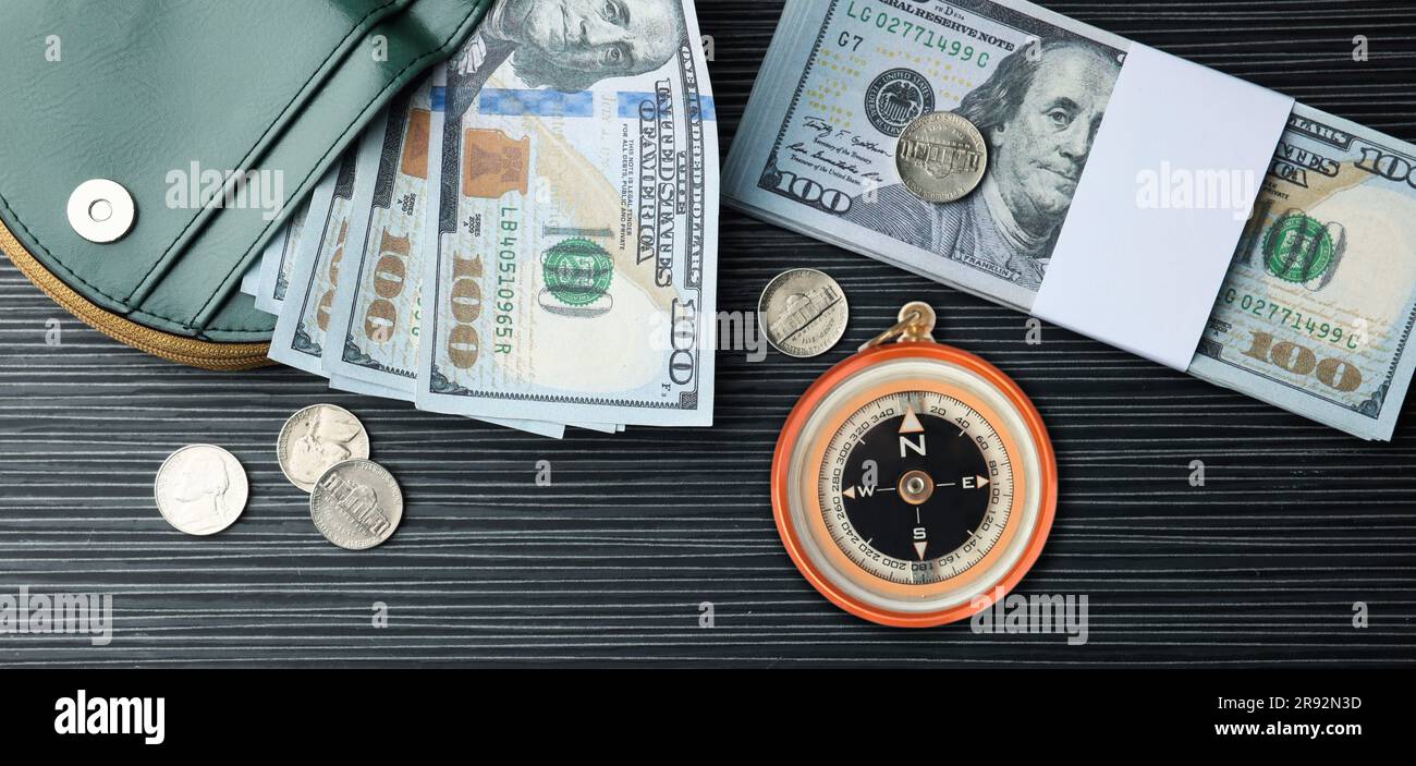 Exchange rate. Wallet, money (dollar banknotes and coins) and compass ...