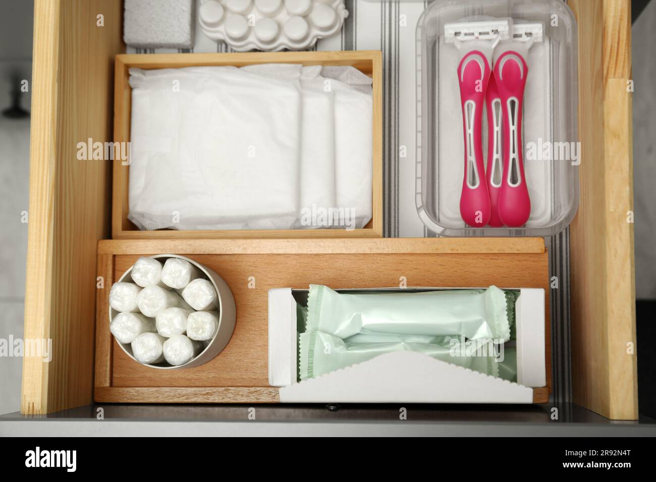 Storage of different feminine hygiene products in wooden drawer, top ...