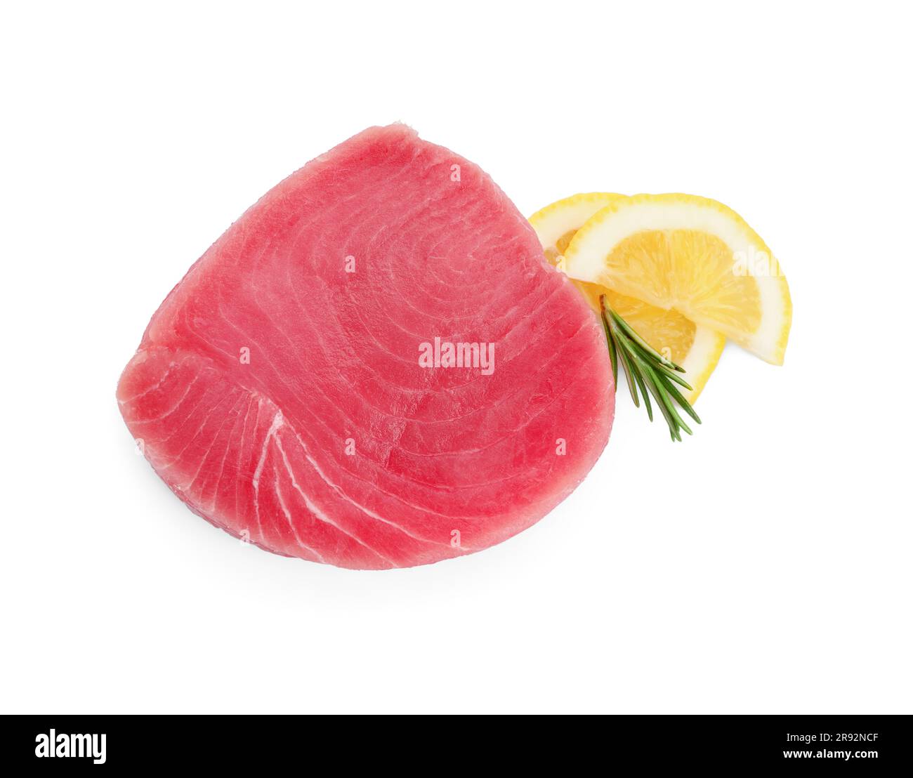 Fresh raw tuna fillet with lemon slices and rosemary on white ...