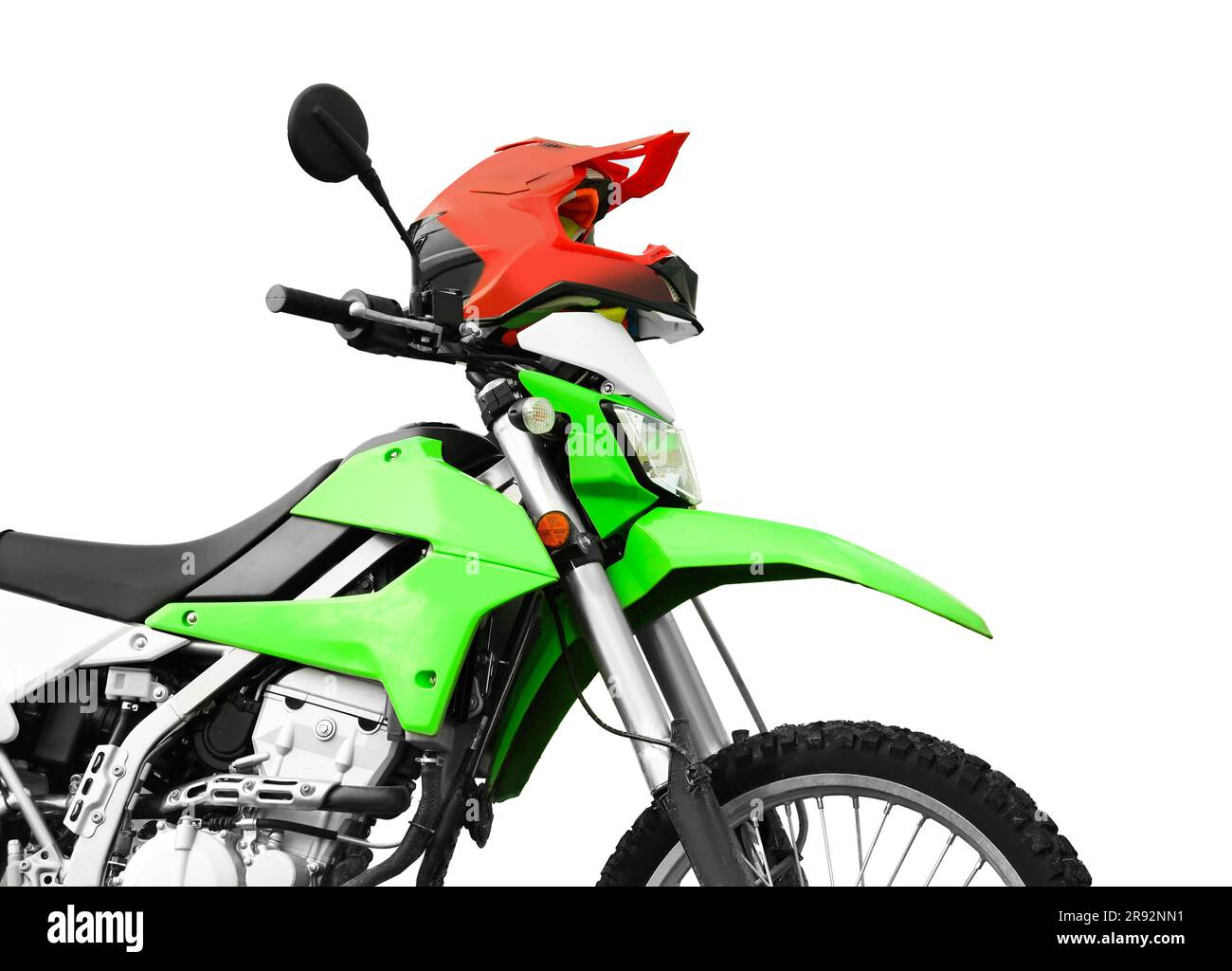 Stylish green cross motorcycle and helmet on white background, closeup ...