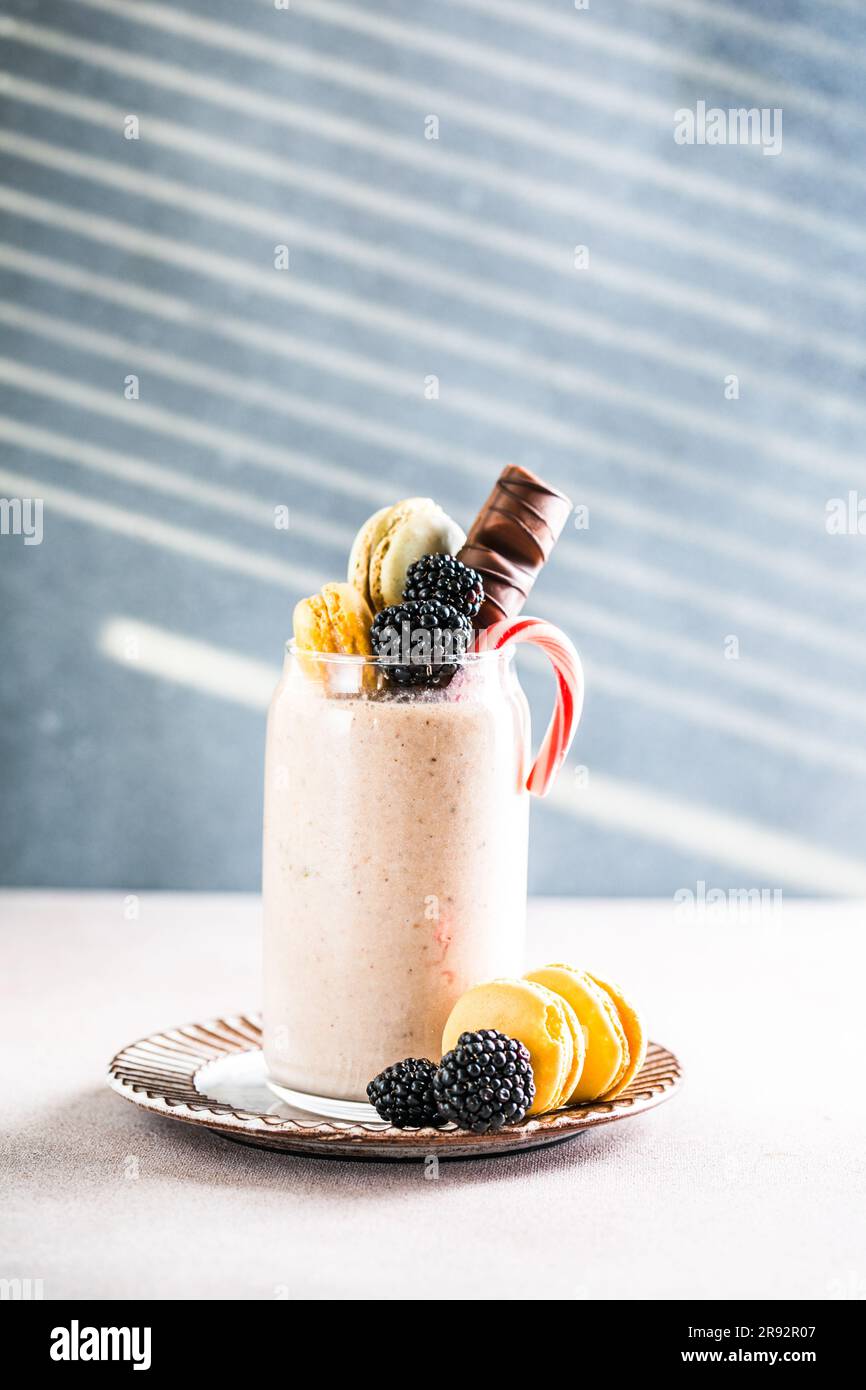 Chocolate indulgent extreme milkshake with macaroons, berry and sweets ...