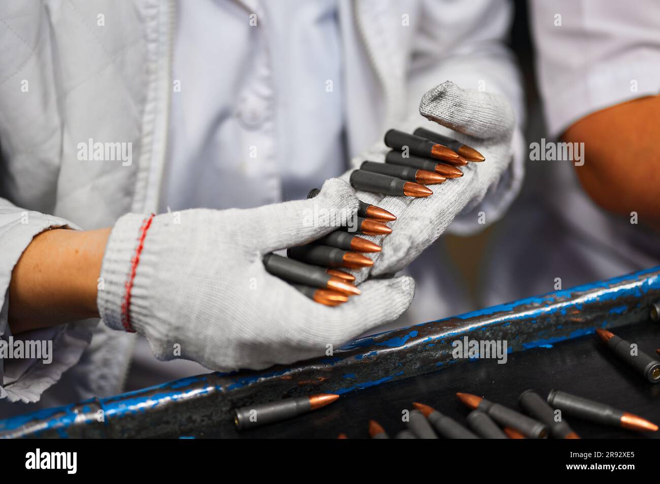 Sorting and selective quality control of weapon cartridges. Hands of ...