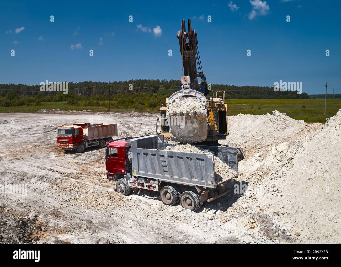 shovel mining excavator loads chalk into tipper truck in quarry Stock ...