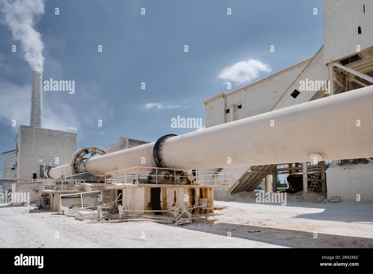 Tubular rotary furnace and smoking chimney at factory Stock Photo - Alamy