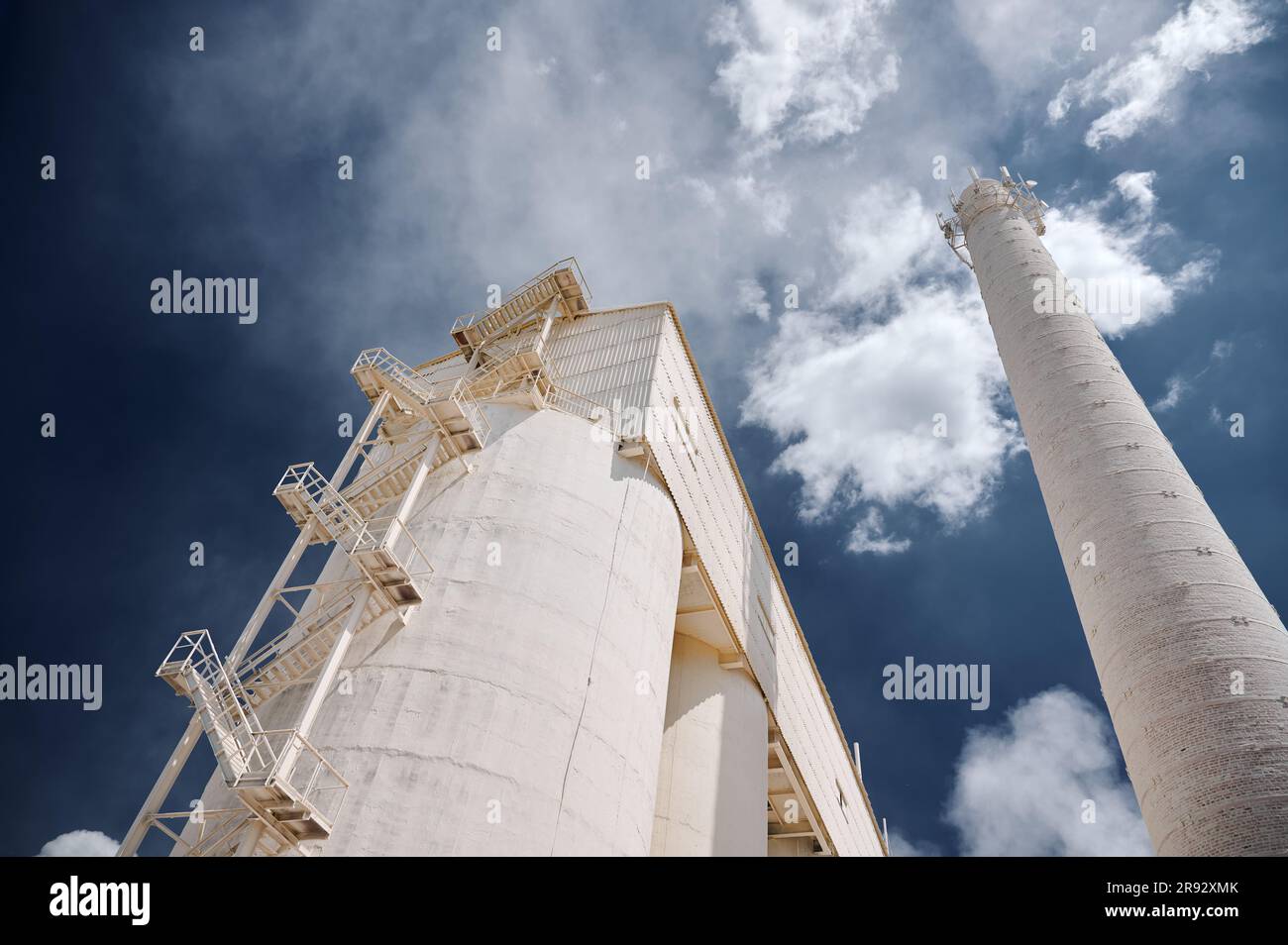 Brick chimney and concrete silos for limestone storage Stock Photo - Alamy