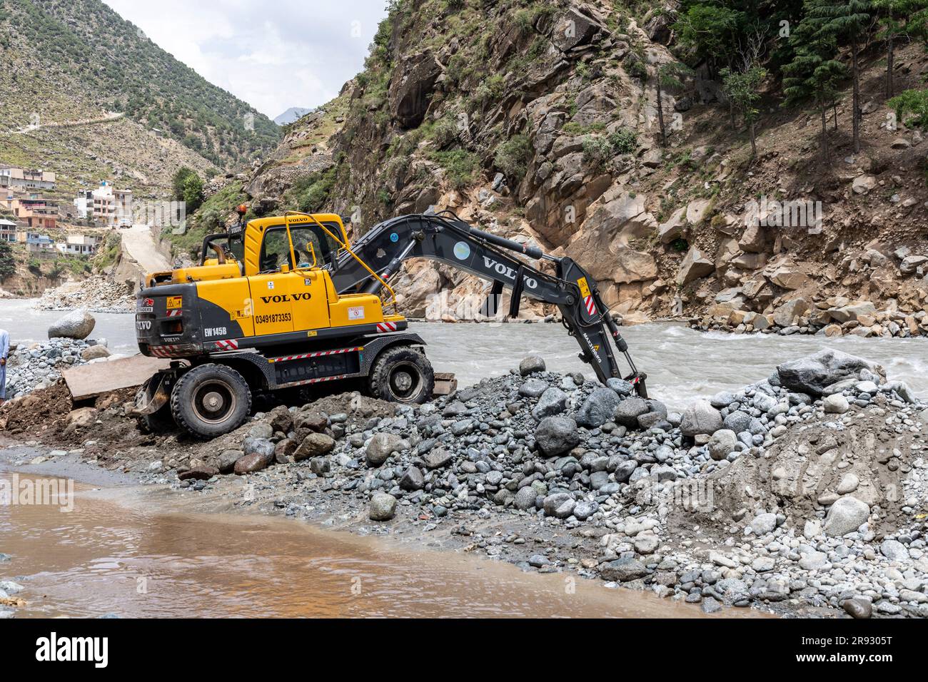 The excavator working to build a barrier to block the flooded water of ...