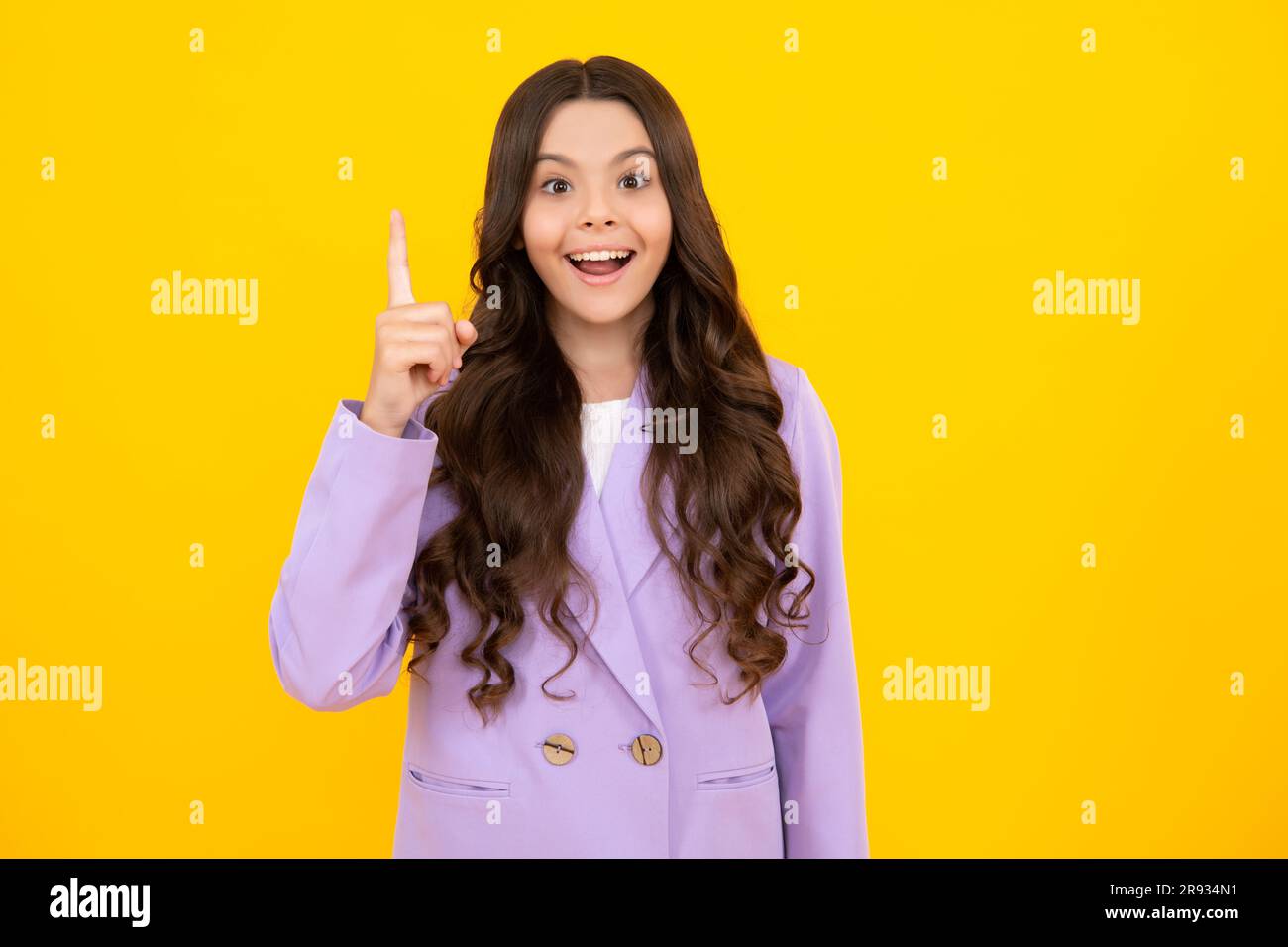 Funny teenager child over isolated yellow background showing and ...